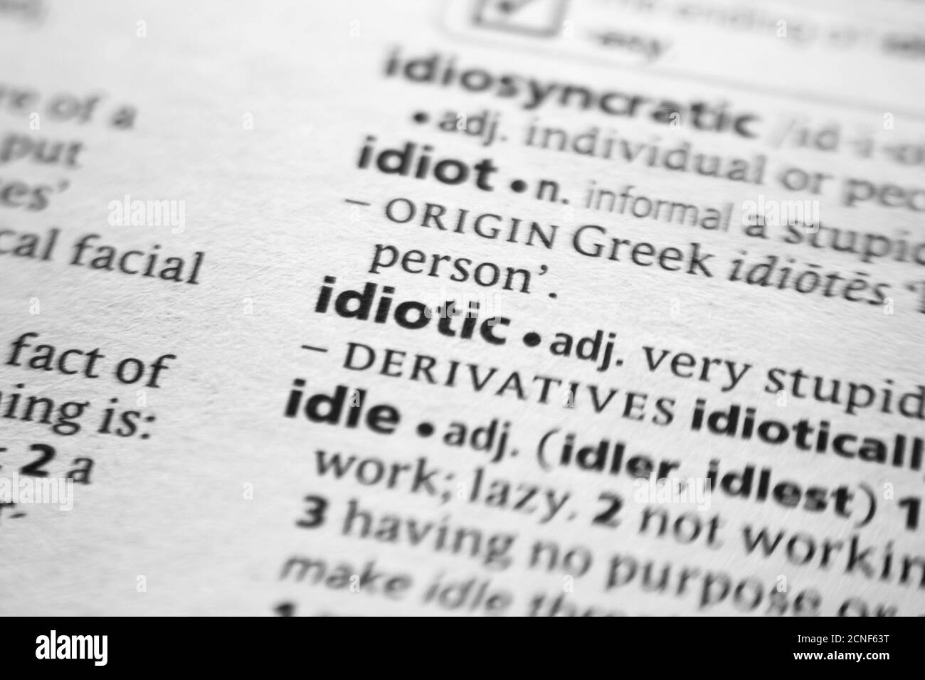 Word or phrase Idiotic in a dictionary Stock Photo - Alamy