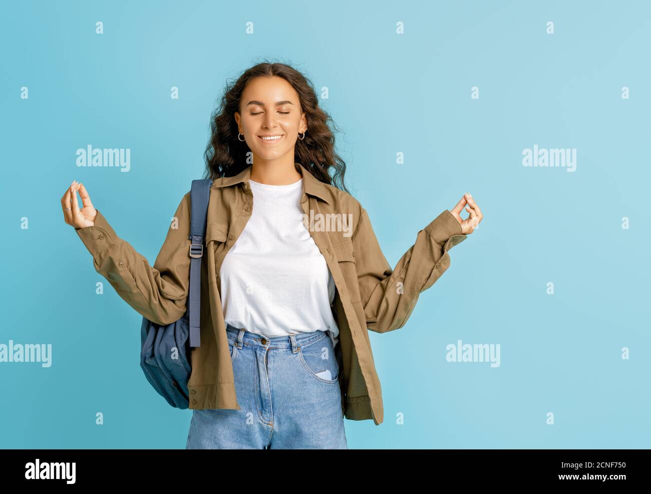Happy emotional young woman posing and laughing on bright blue ...