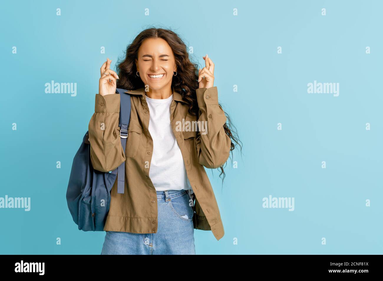 Happy emotional young woman posing and laughing on bright blue ...