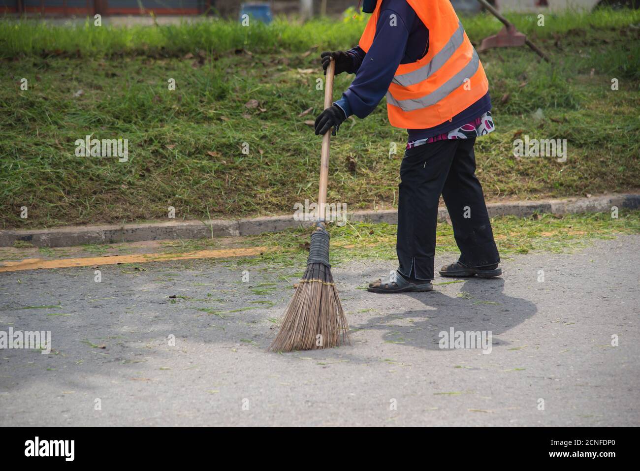 Road sweeper worker cleaning city street with broom tool in Thailand ...