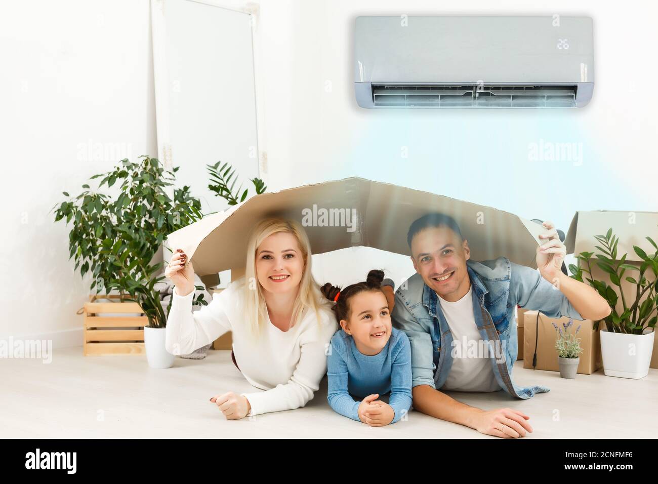 air conditioning in living room with happy family moving to new ...