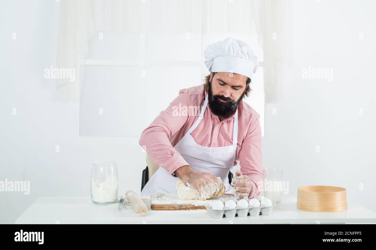 skilled baker use kitchen utensils for cooking. male chef in hat ...