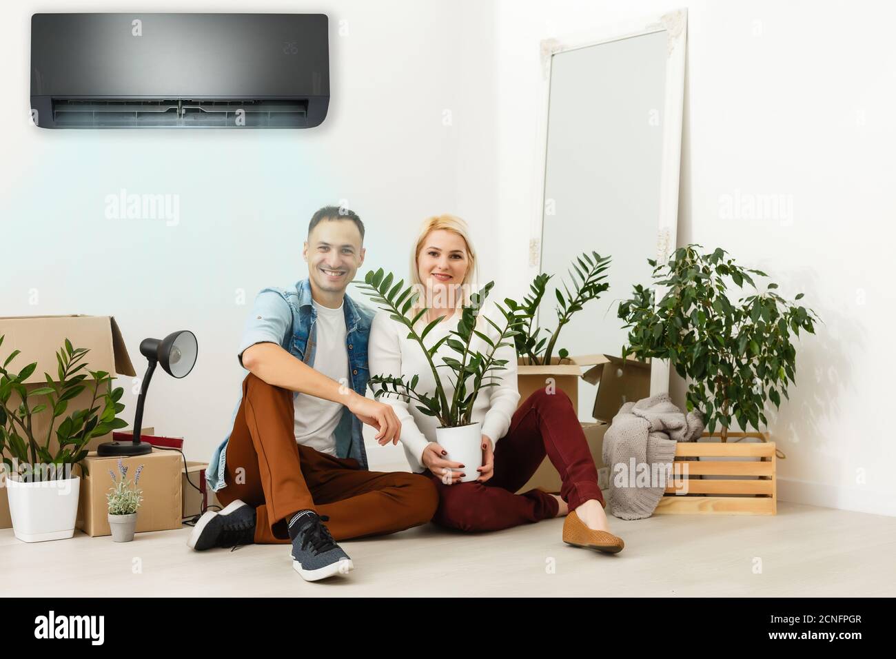 Happy Family Under Air Conditioning At Home Stock Photo - Alamy