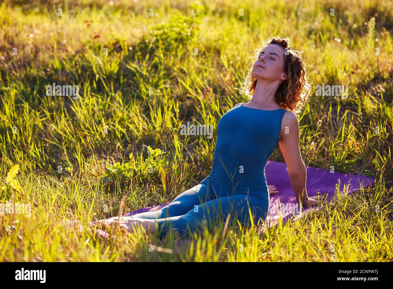 Beautiful yoga woman stretching on mat alone during lockdown.Pretty ...