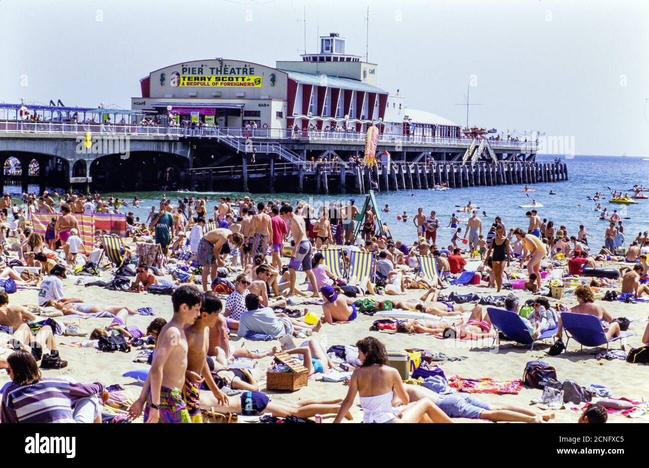 Holidaymakers enjoy the sun, sea and sand on Bournemouth Beach on the ... Holidaymakers enjoy the sun, sea and sand on Bournemouth Beach on the ...