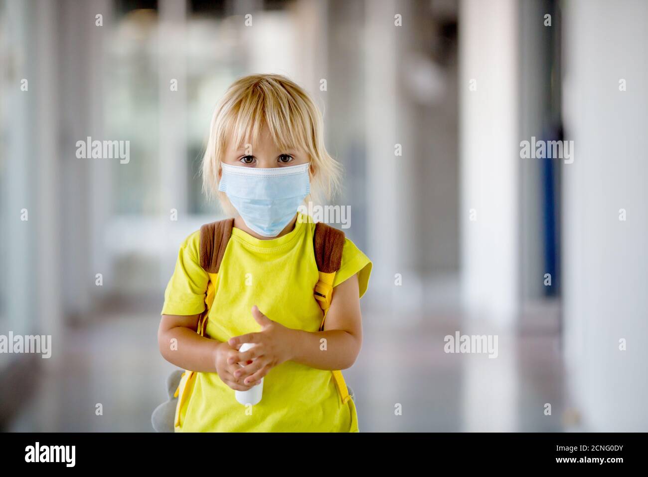 Toddler boy, child wearing face masks and using disinfection at the ...