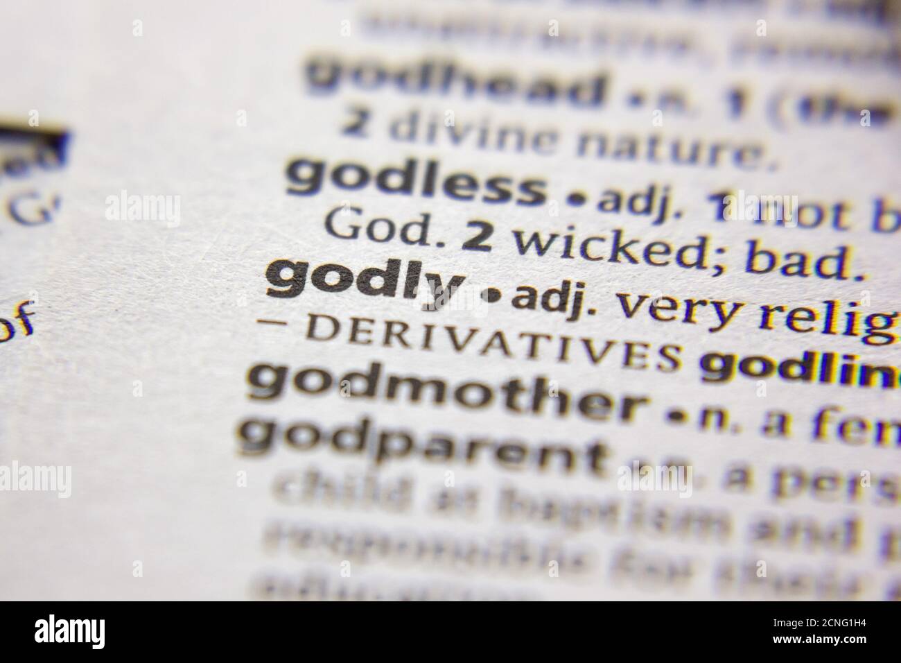 Word or phrase Godly in a dictionary Stock Photo - Alamy