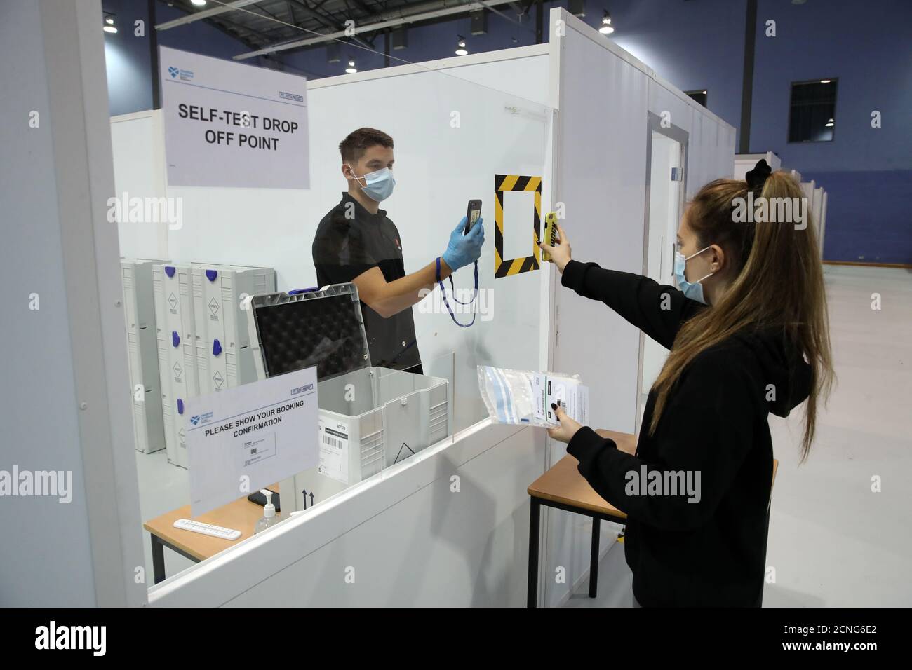 Kitty Ritchie has her QR code scanned as she deposits her sample as she ...
