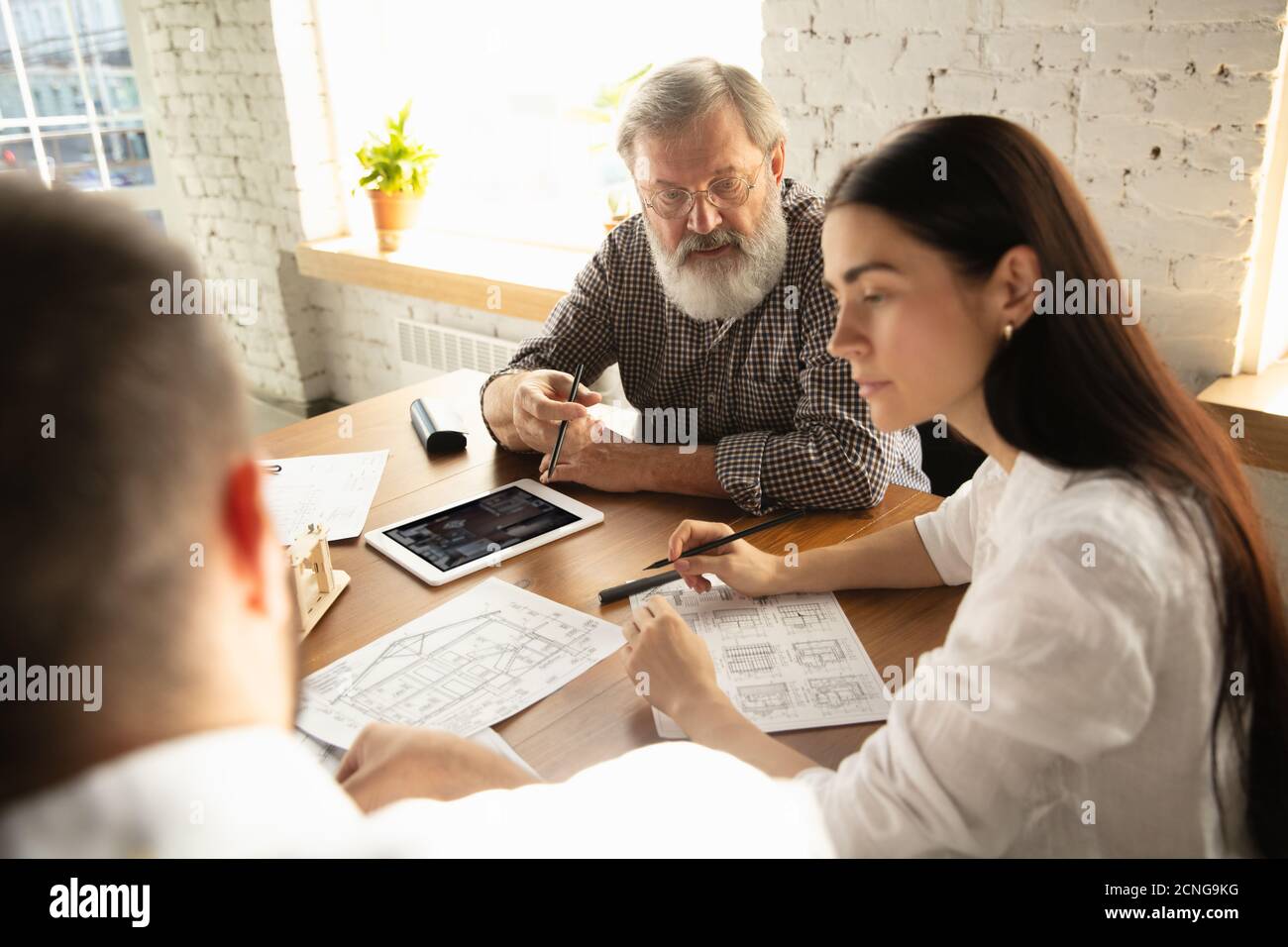Male architect-engineer presents project of future house for young ...