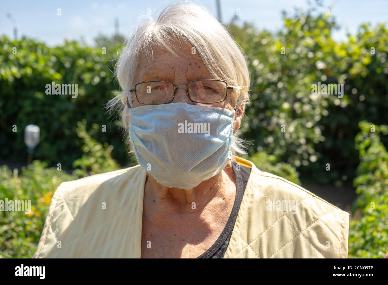 old lady with grey hair wear protection mask, elderly woman at home on ...