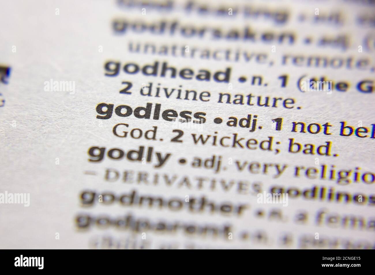 Word or phrase Godless in a dictionary Stock Photo - Alamy
