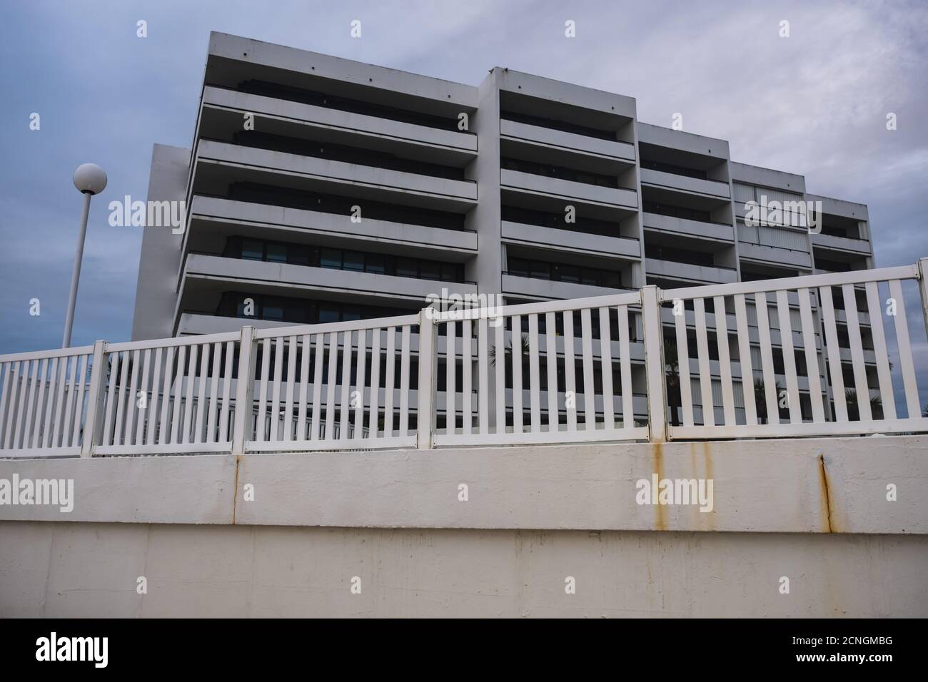 Modern structural building behind a gate Stock Photo - Alamy