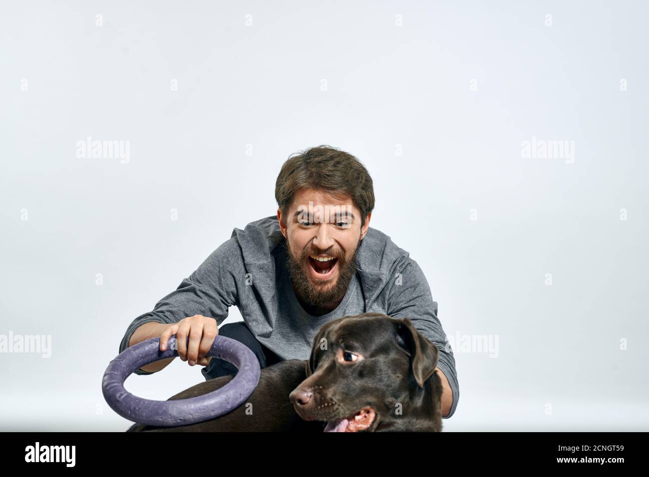 happy owner with pet black dog training model emotions Stock Photo - Alamy