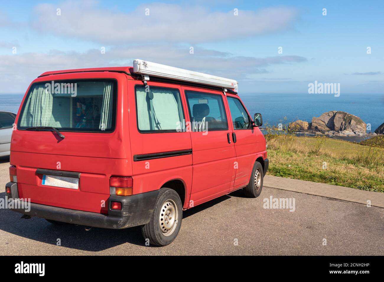 Spain; Sep 2020: Vintage red van parked in front of the ocean ...