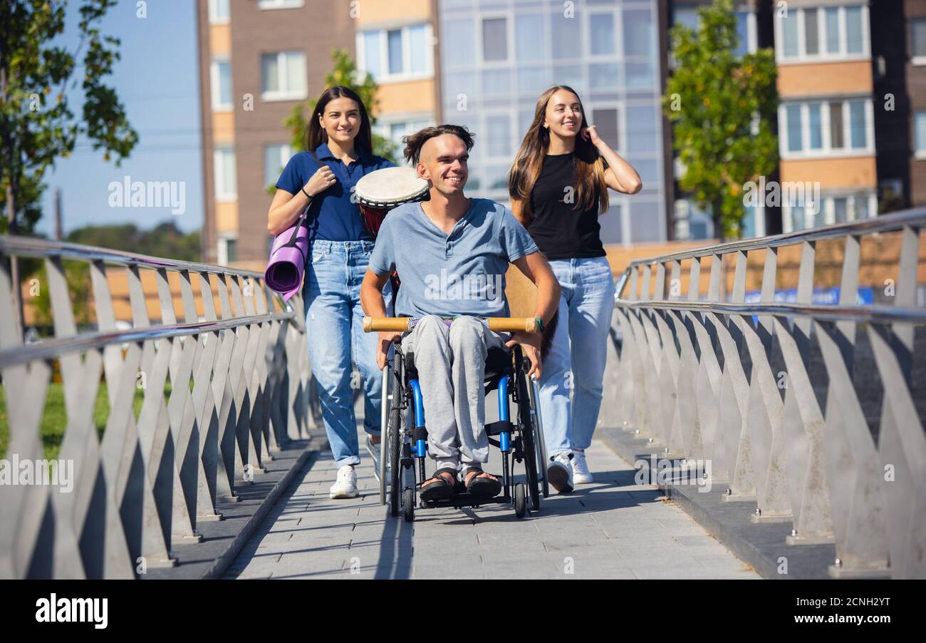 Emotions. Happy handicapped man on a wheelchair spending time with ...