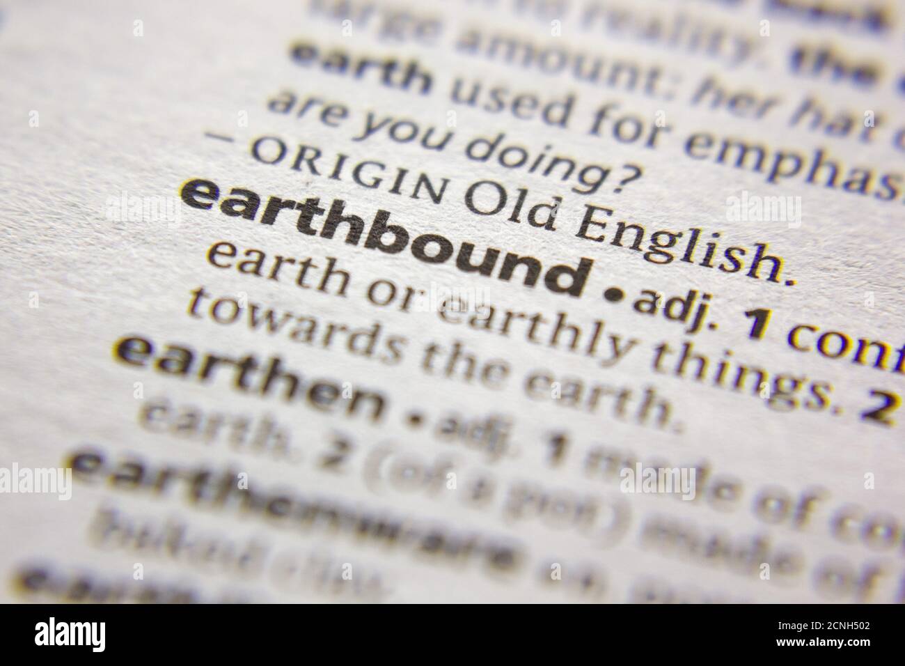 Word or phrase Earthbound in a dictionary Stock Photo - Alamy
