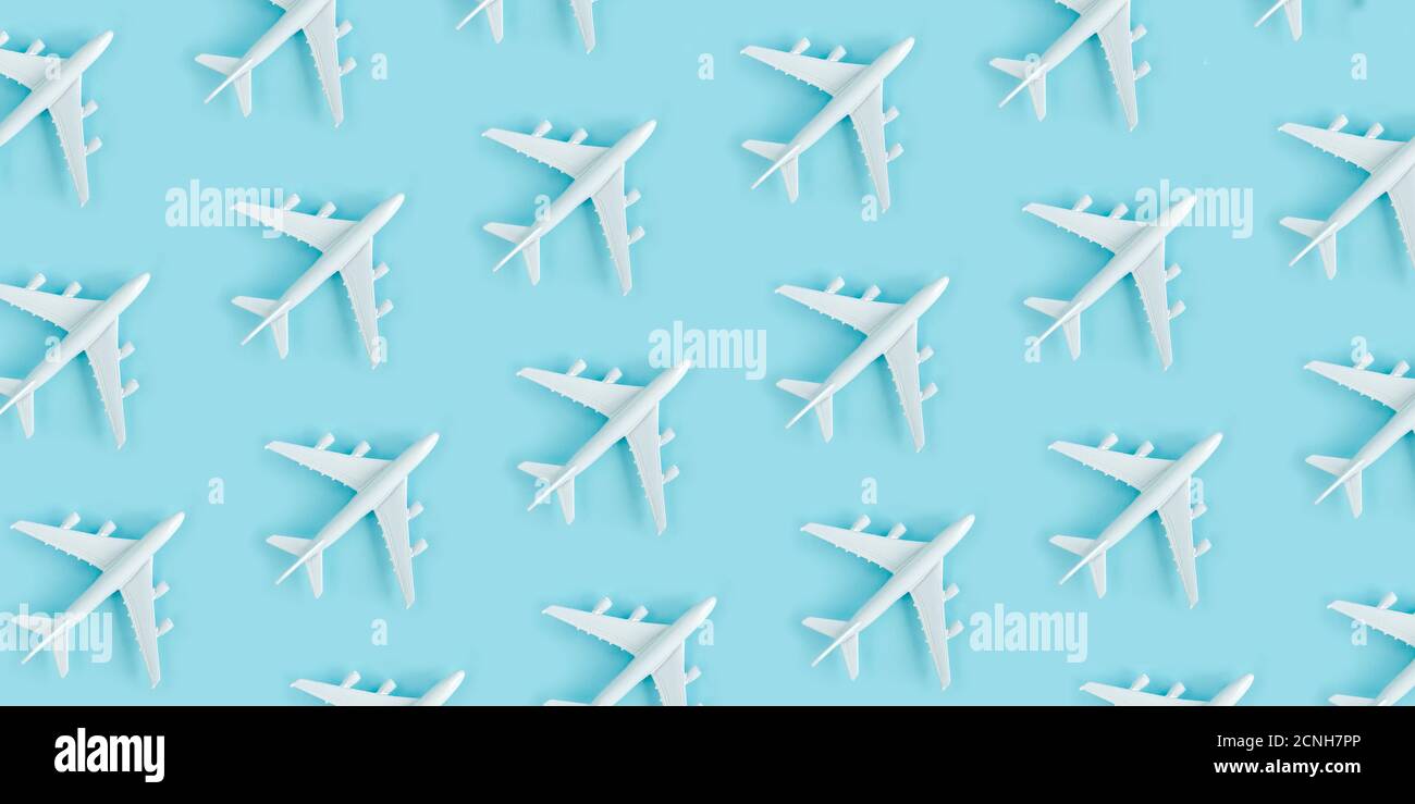 White model plane, airplane on blue background. Top view, flat lay ...