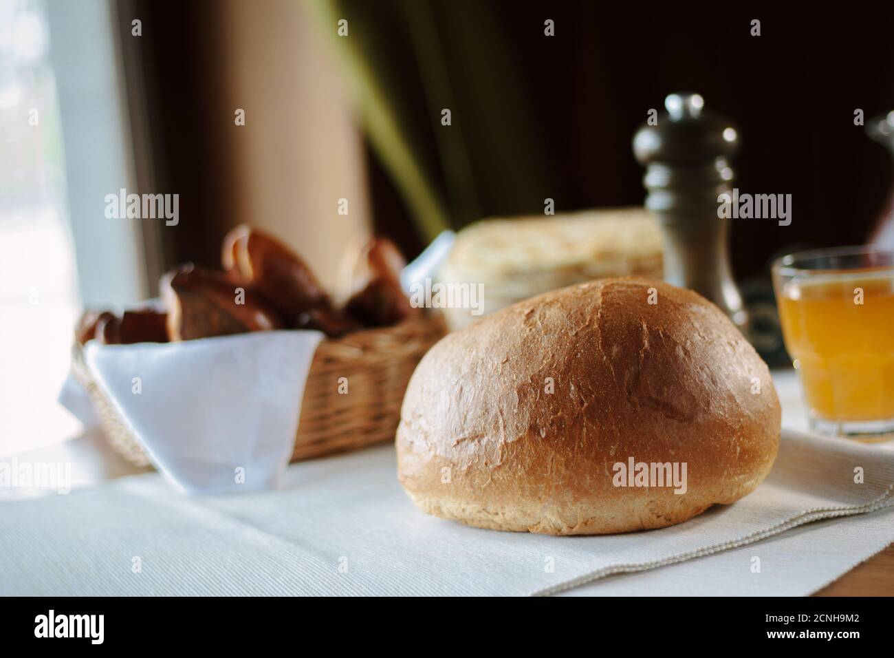 Fresh round bread at the restaurant table Stock Photo - Alamy