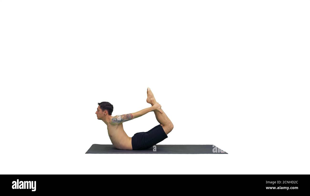 Sporty muscular young yogi man doing backbend exercise, dhanuras Stock ...
