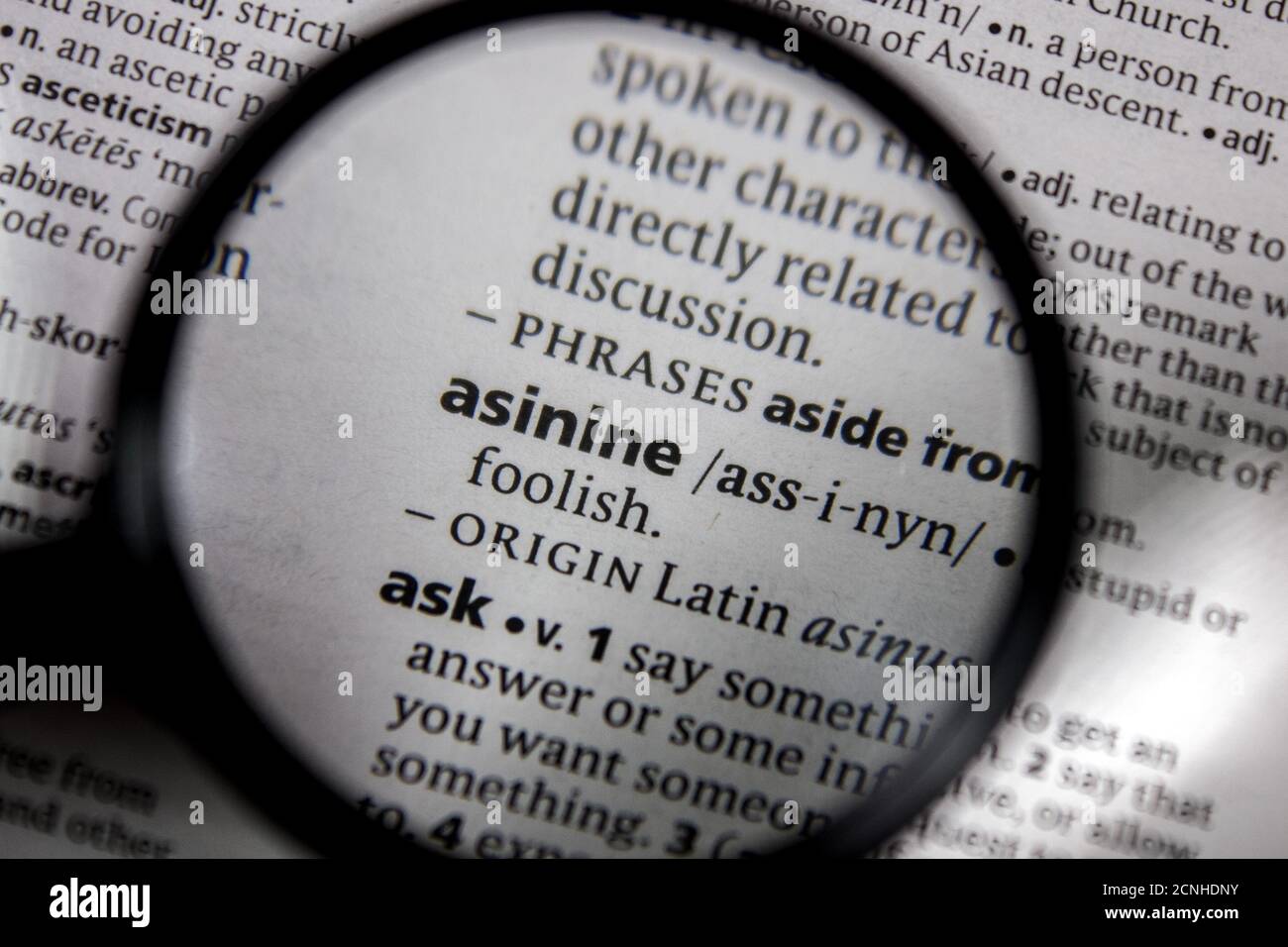 The word or phrase asinine in a dictionary book Stock Photo - Alamy