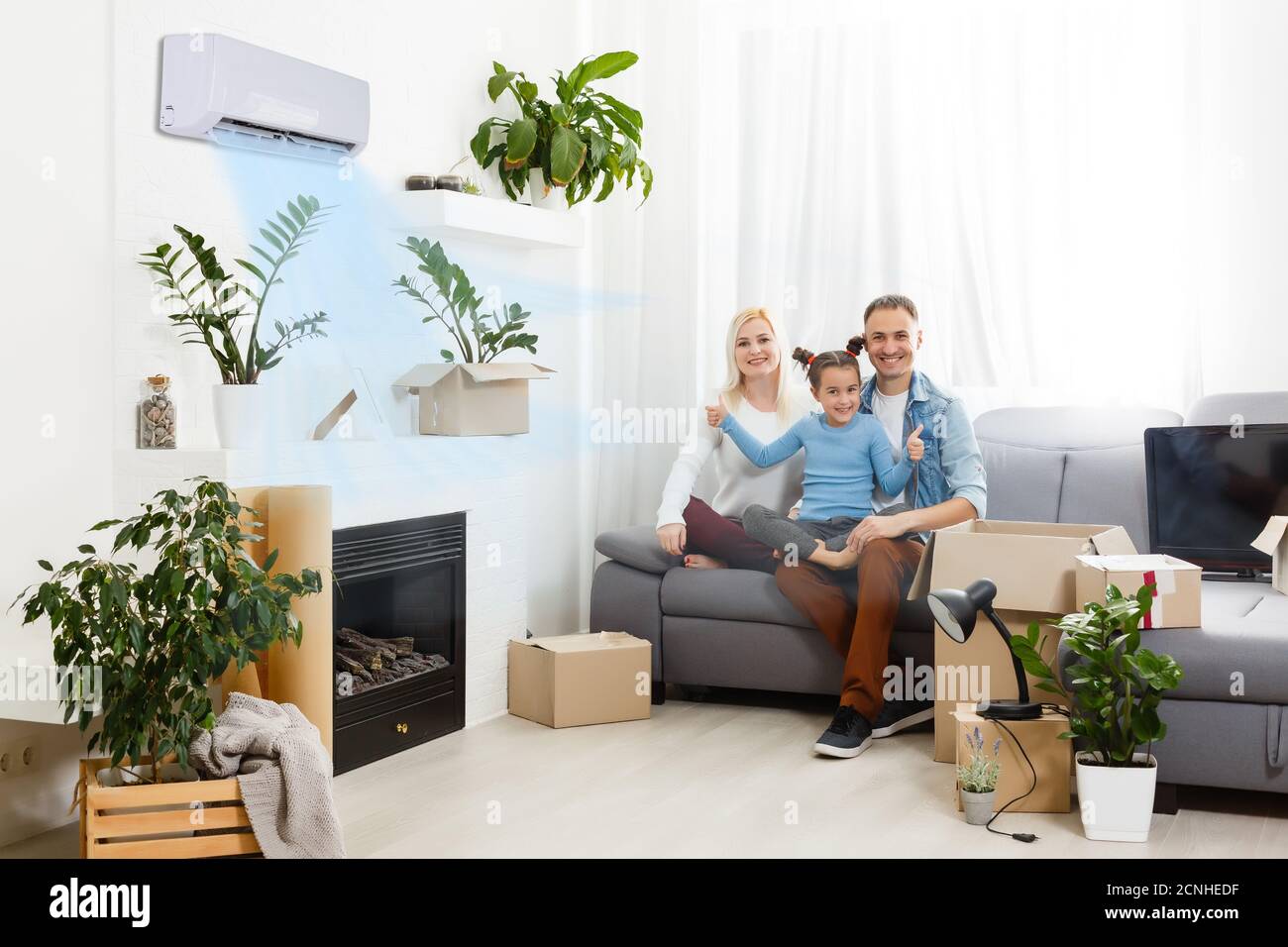 Happy Family Under Air Conditioning At Home Stock Photo - Alamy