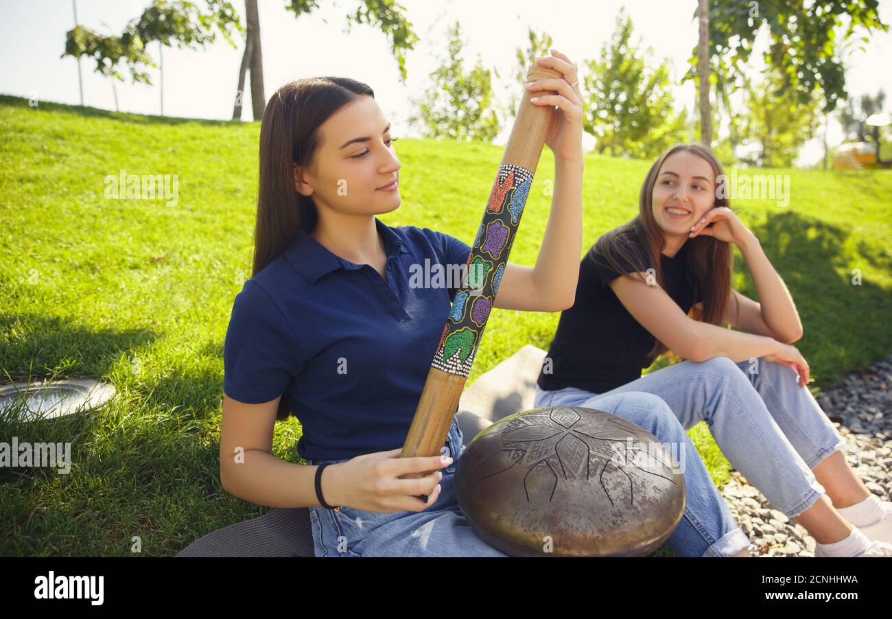 Two girls playing musical instruments hi-res stock photography and ...