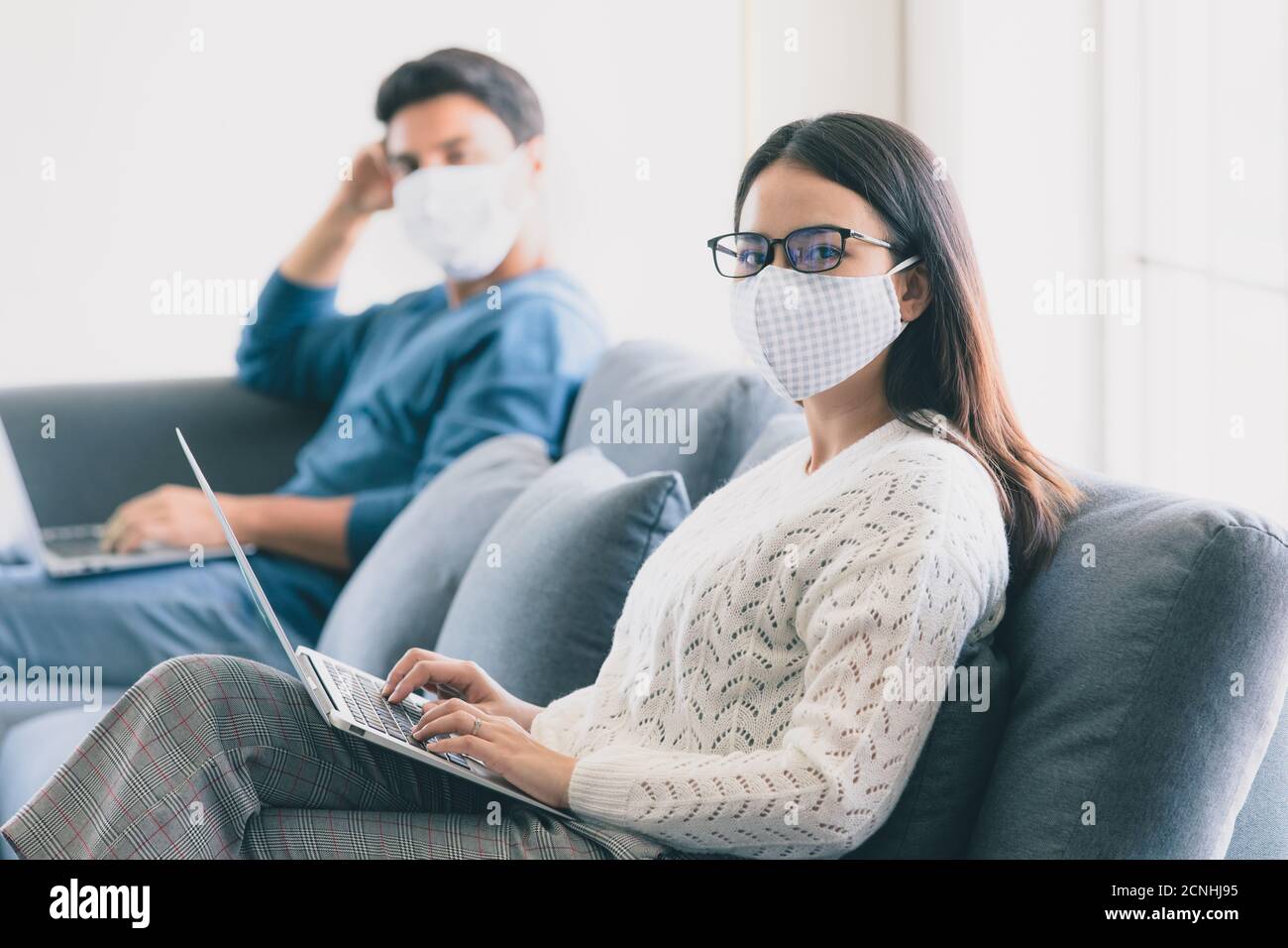 Cute pretty Asian woman wearing medical protective mask on face using ...