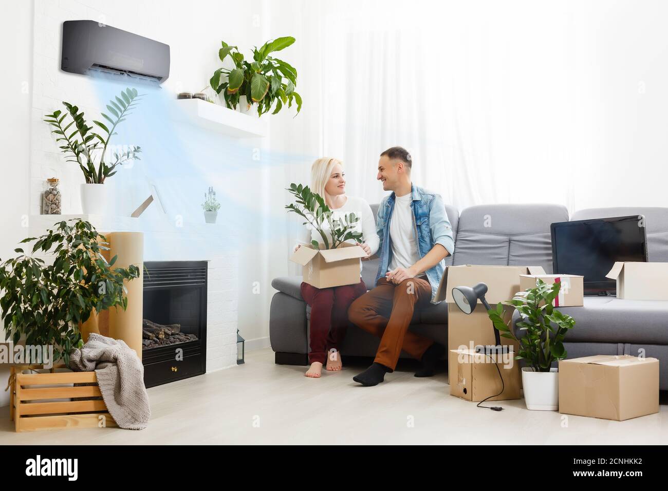 Happy Family Under Air Conditioning At Home Stock Photo - Alamy