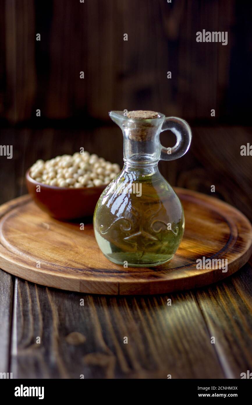 Natural soy bean oil with soybeans near it Stock Photo - Alamy
