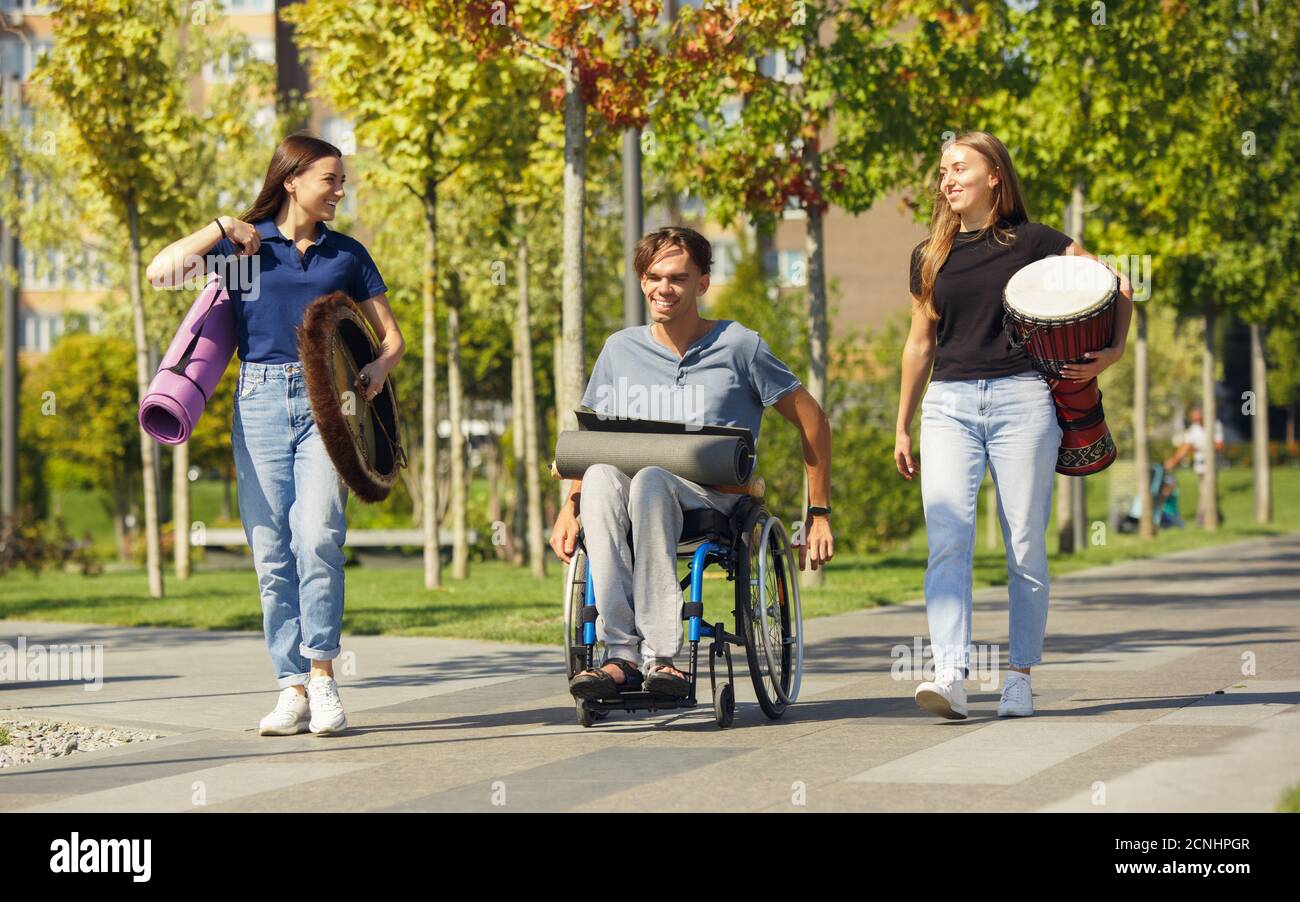 Summer. Happy caucasian handicapped man on a wheelchair spending time ...
