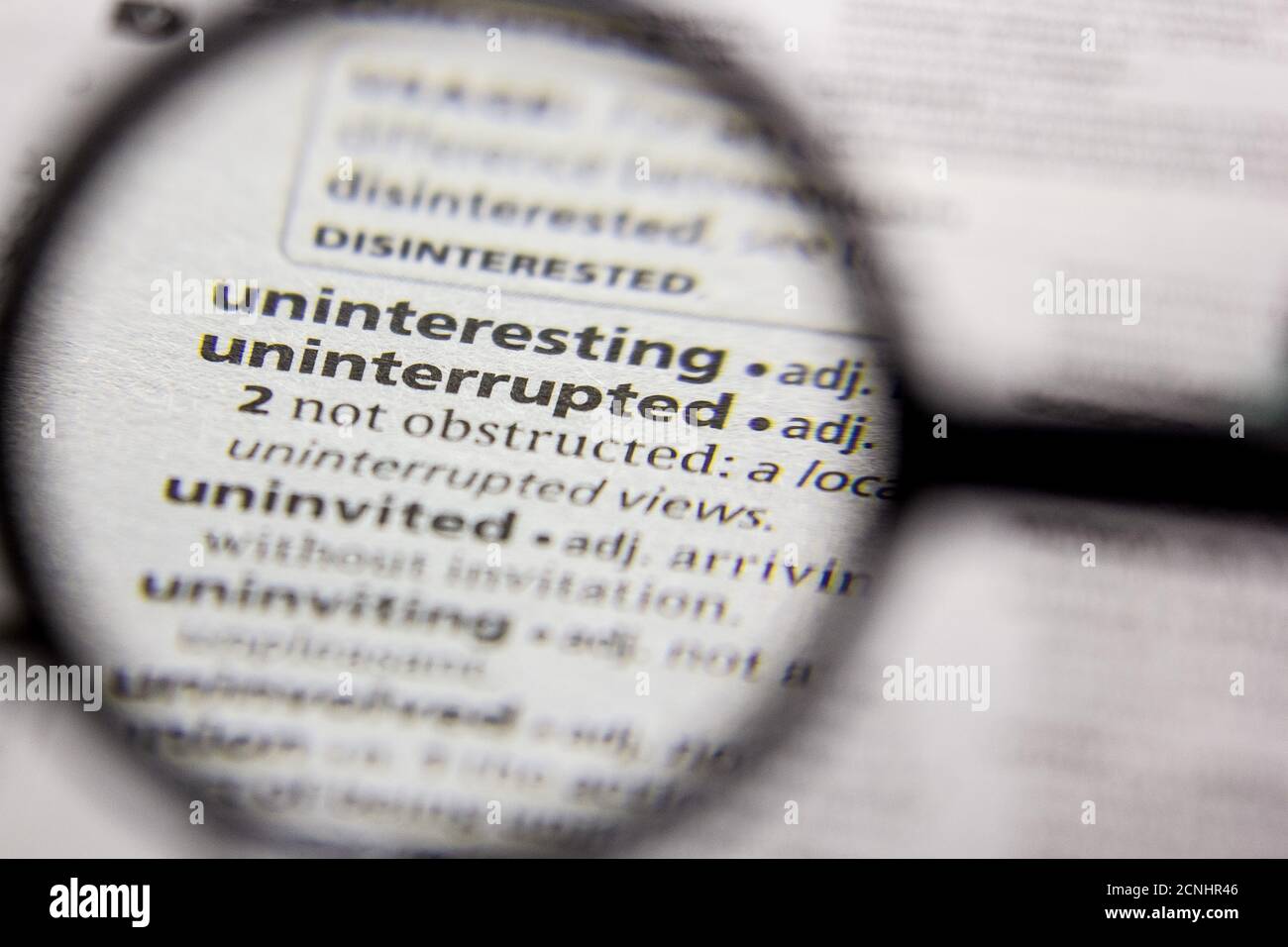 Word or phrase Uninterrupted in a dictionary Stock Photo - Alamy