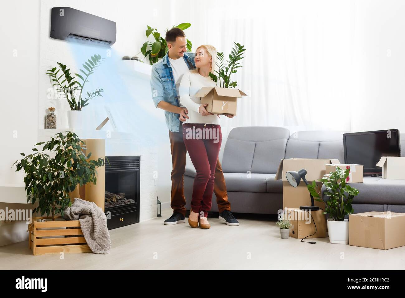 air conditioning in living room with happy family moving to new ...