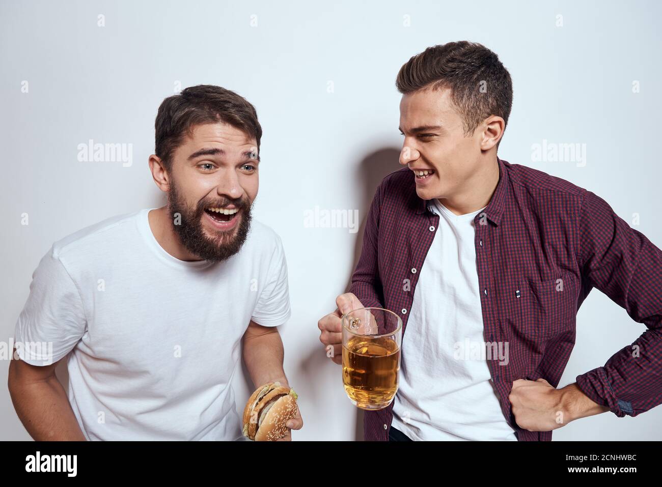 Two cheerful friends drinking beer drunk fun lifestyle communication ...