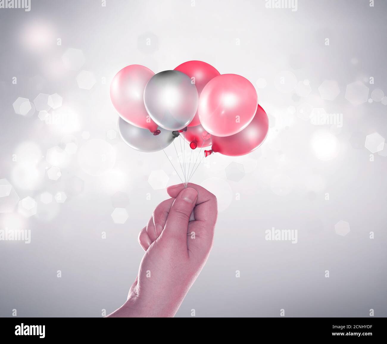Hand with balloons Stock Photo - Alamy