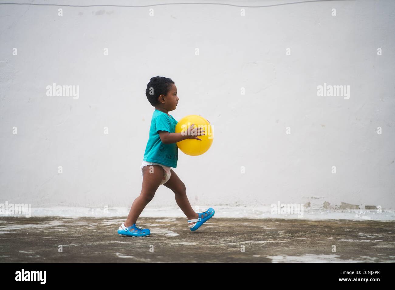 Kid with an Yellow ball Stock Photo - Alamy