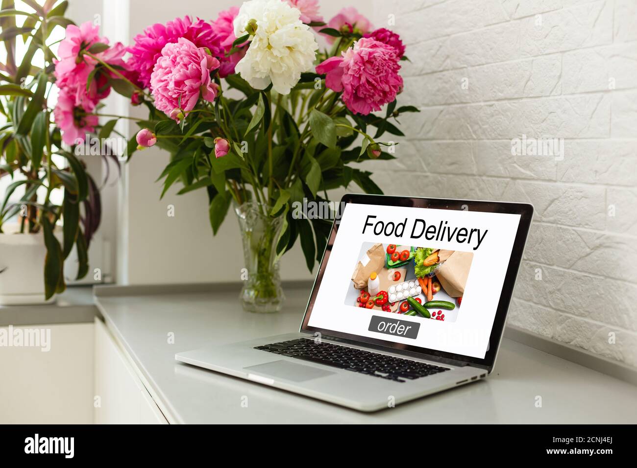 Food take away website in a laptop screen. Lunch at the office Stock ...