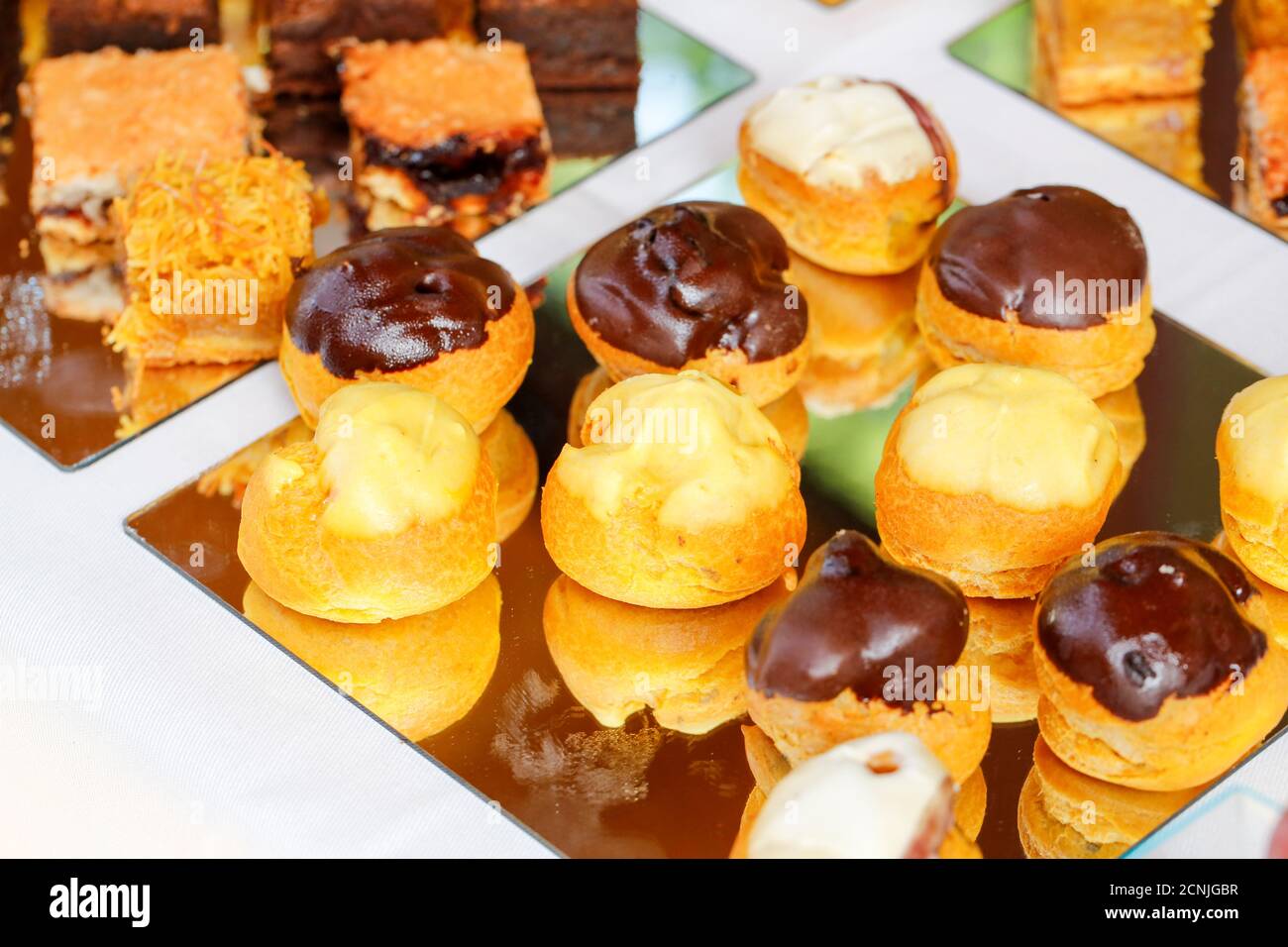 Buffett of sweets and cream puffs at wedding reception and ceremony ...