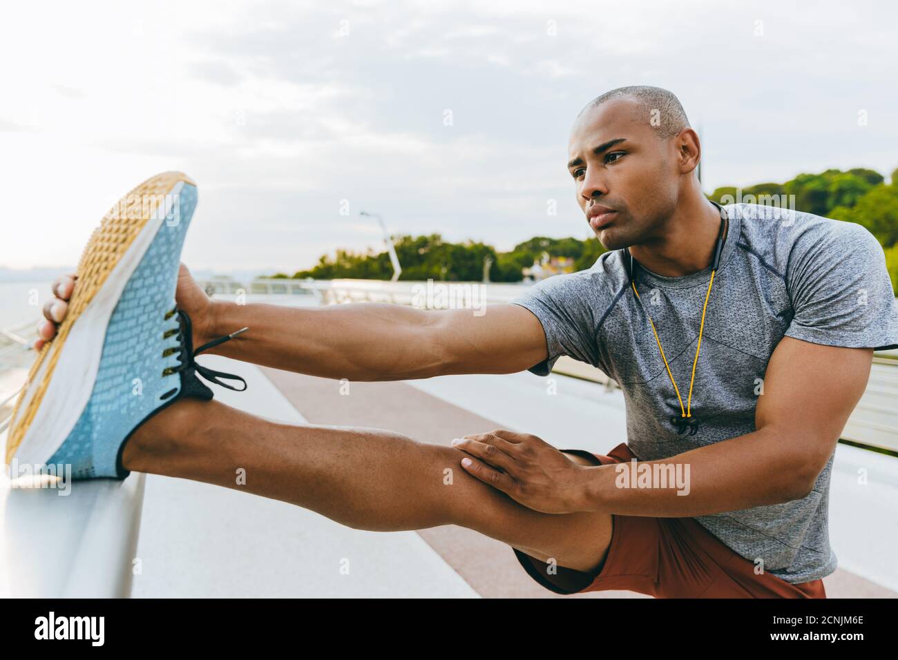 Confident young african sports man stretching on the bridge Stock Photo ...