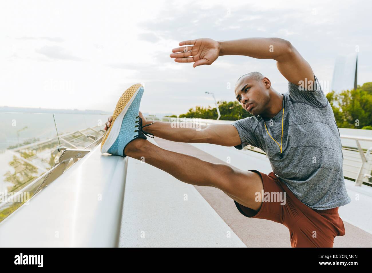 Confident young african sports man stretching on the bridge Stock Photo ...