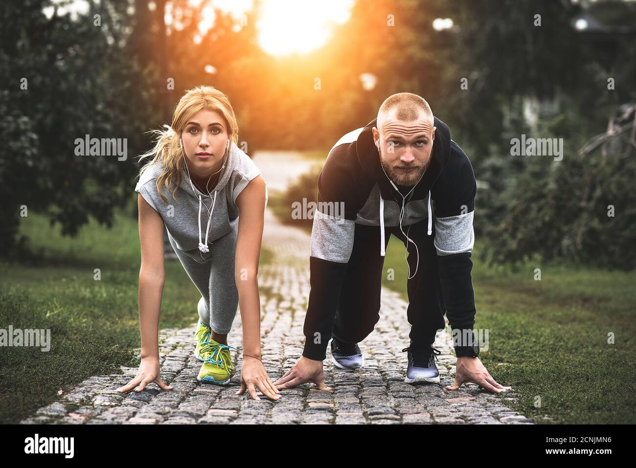 City running couple jogging outside. Runners training outdoors working ...