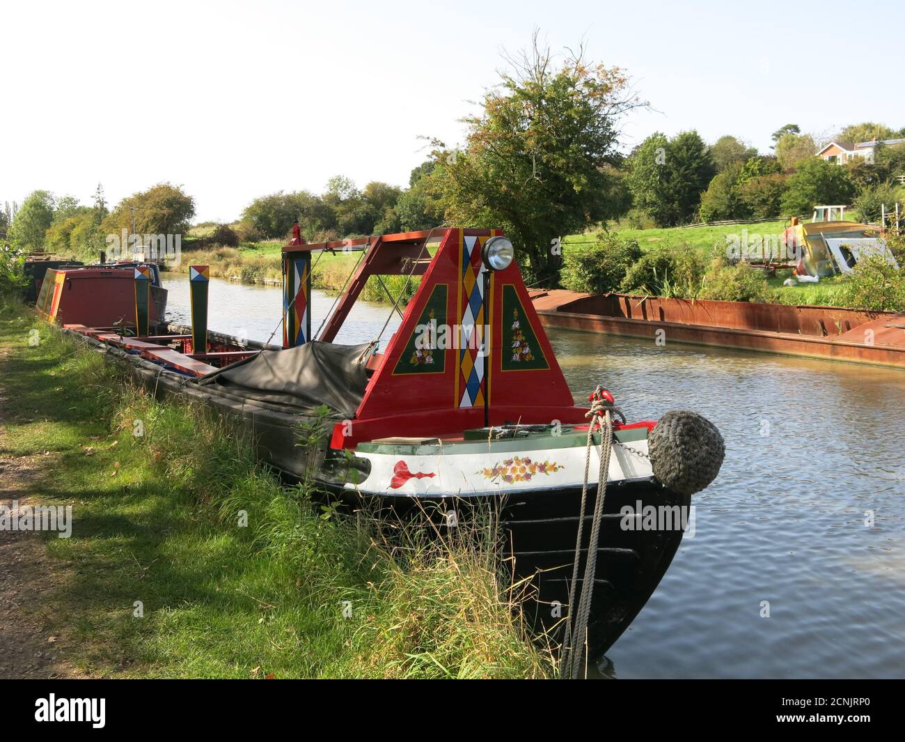 A commercial freight barge is moored up alongside the towpath on the ...