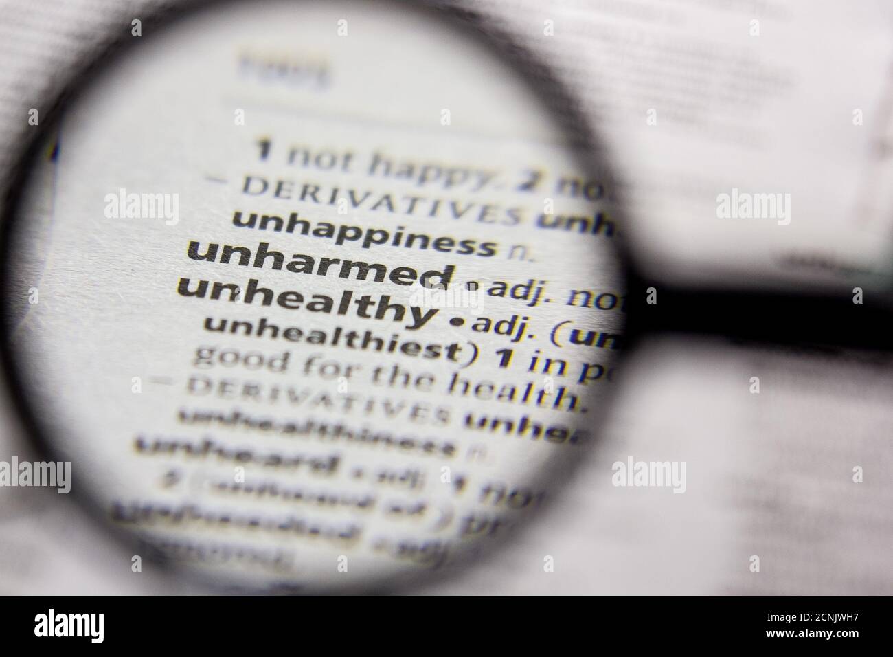 Word or phrase Unharmed in a dictionary Stock Photo - Alamy