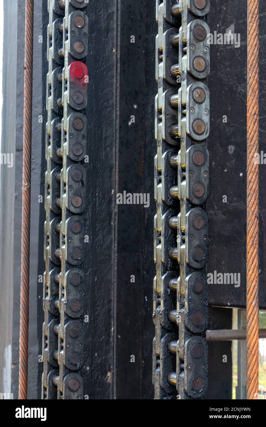 Close up of a heavy industrial chain in use for moving heavy objects ...