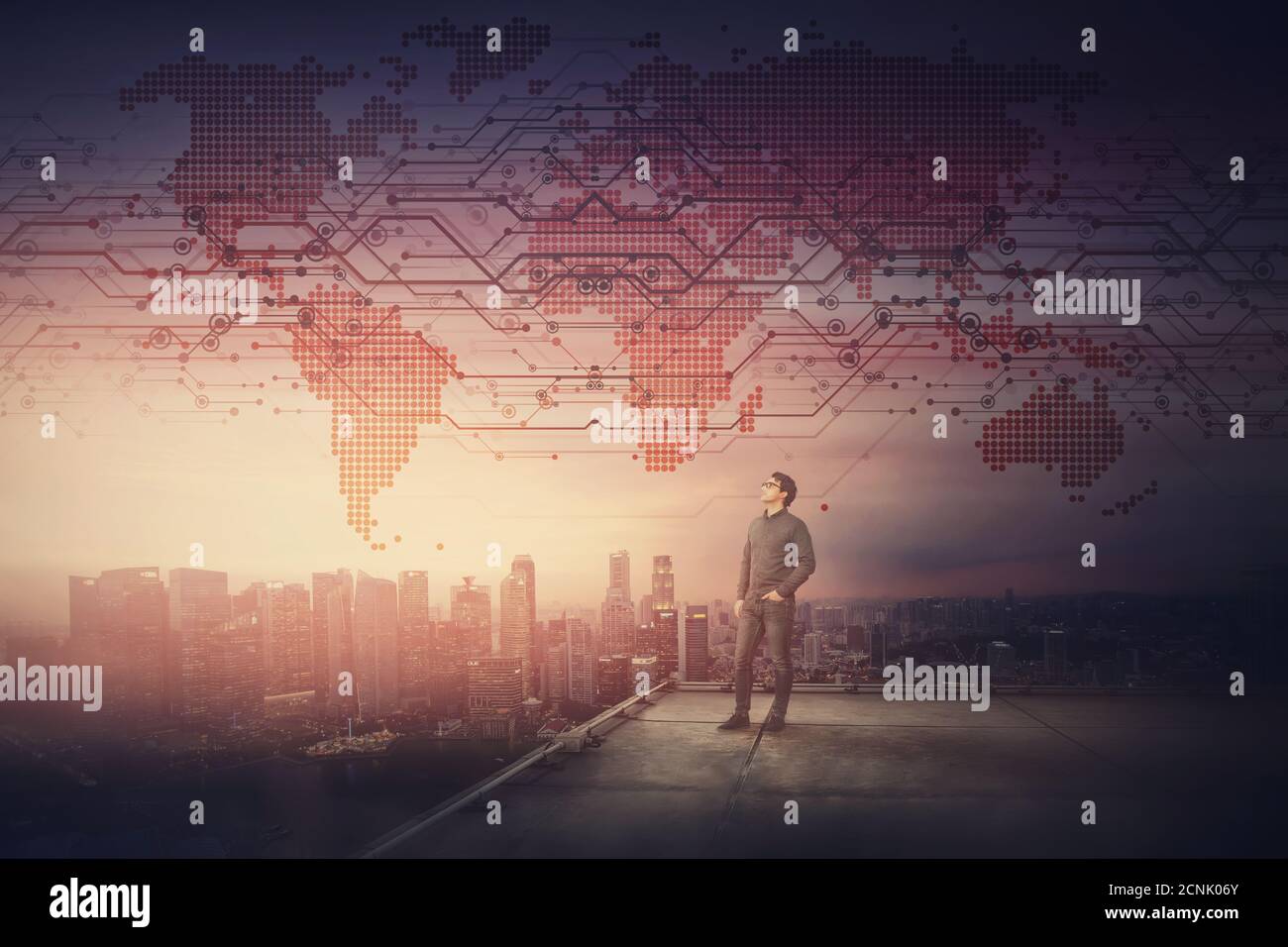 Conceptual sunset scene with a businessman on the rooftop watching ...