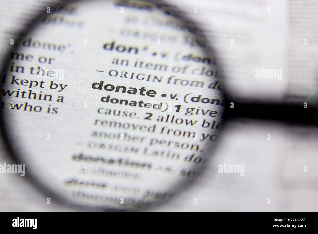 Word or phrase Donate in a dictionary Stock Photo - Alamy