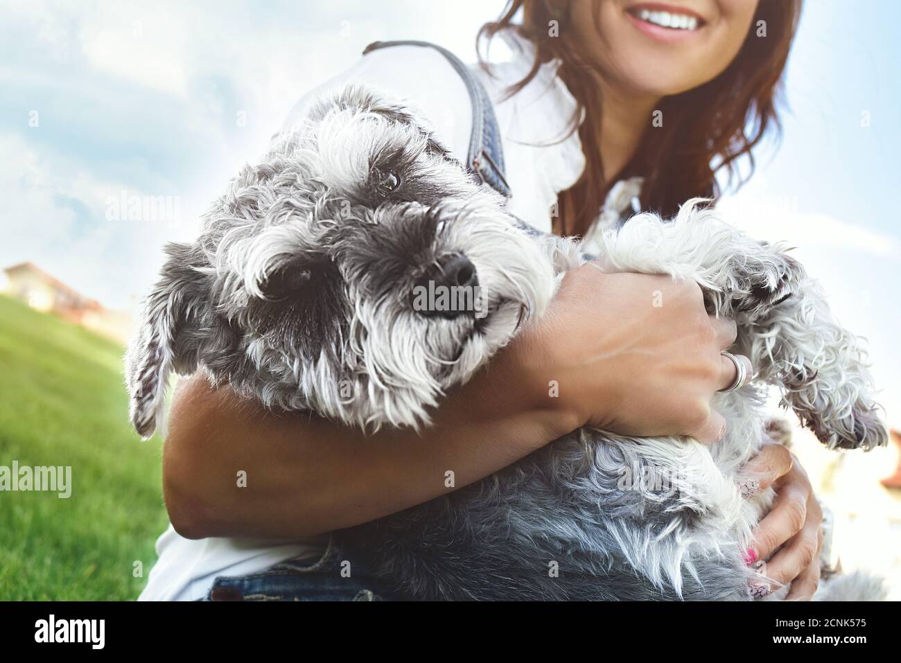 Portrait of a happy caucasian woman who hugs her beloved dog.The ...