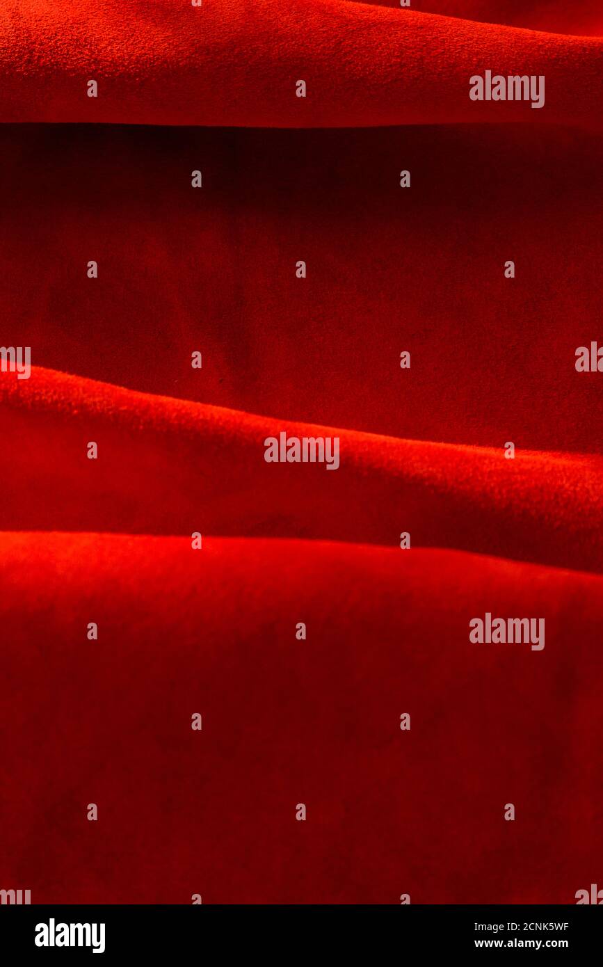 Dark red matte background of suede fabric, closeup. Velvet texture of ...