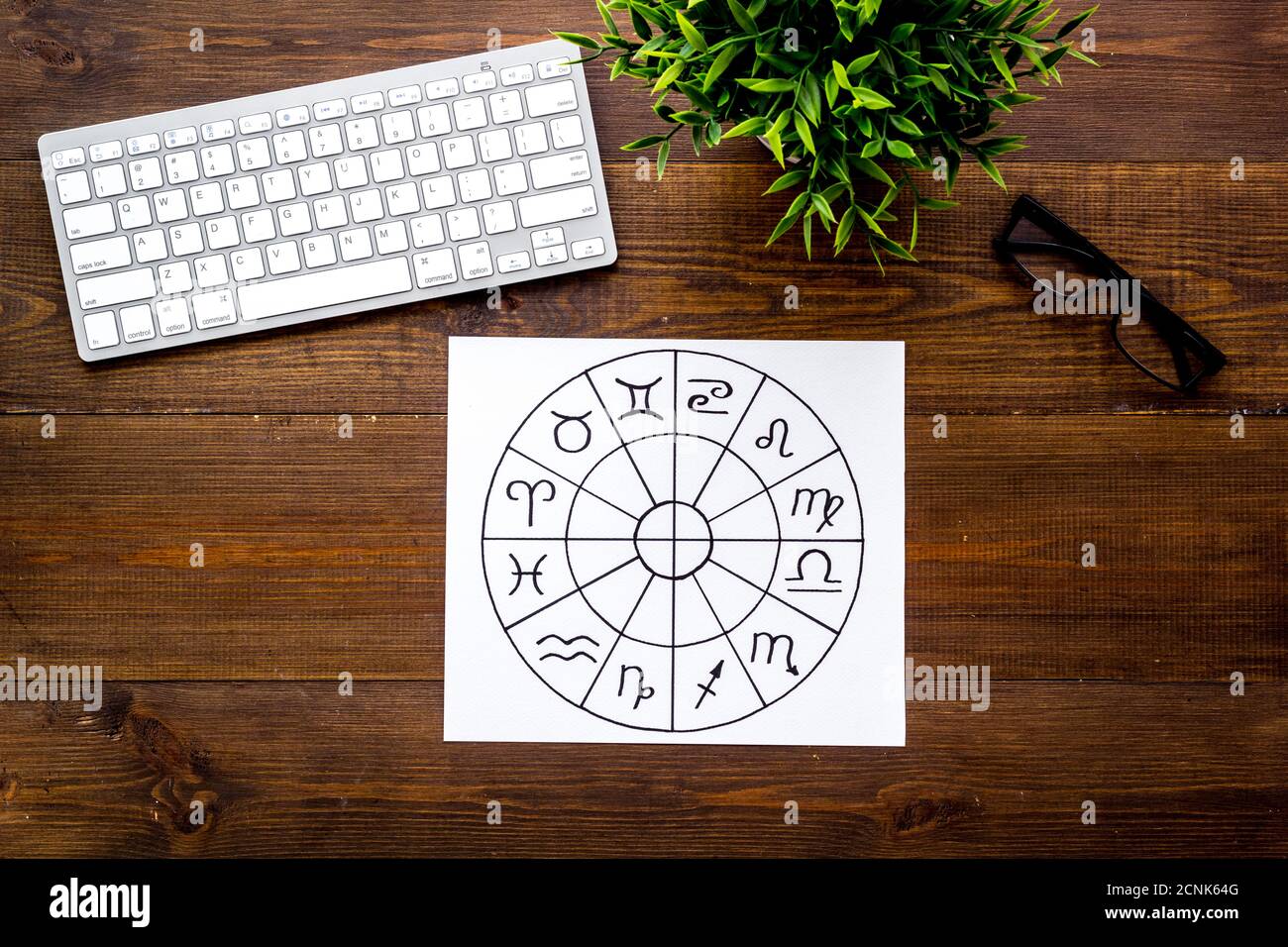 Top view of horoscopic wheel with Zodiac signs on work table Stock ...