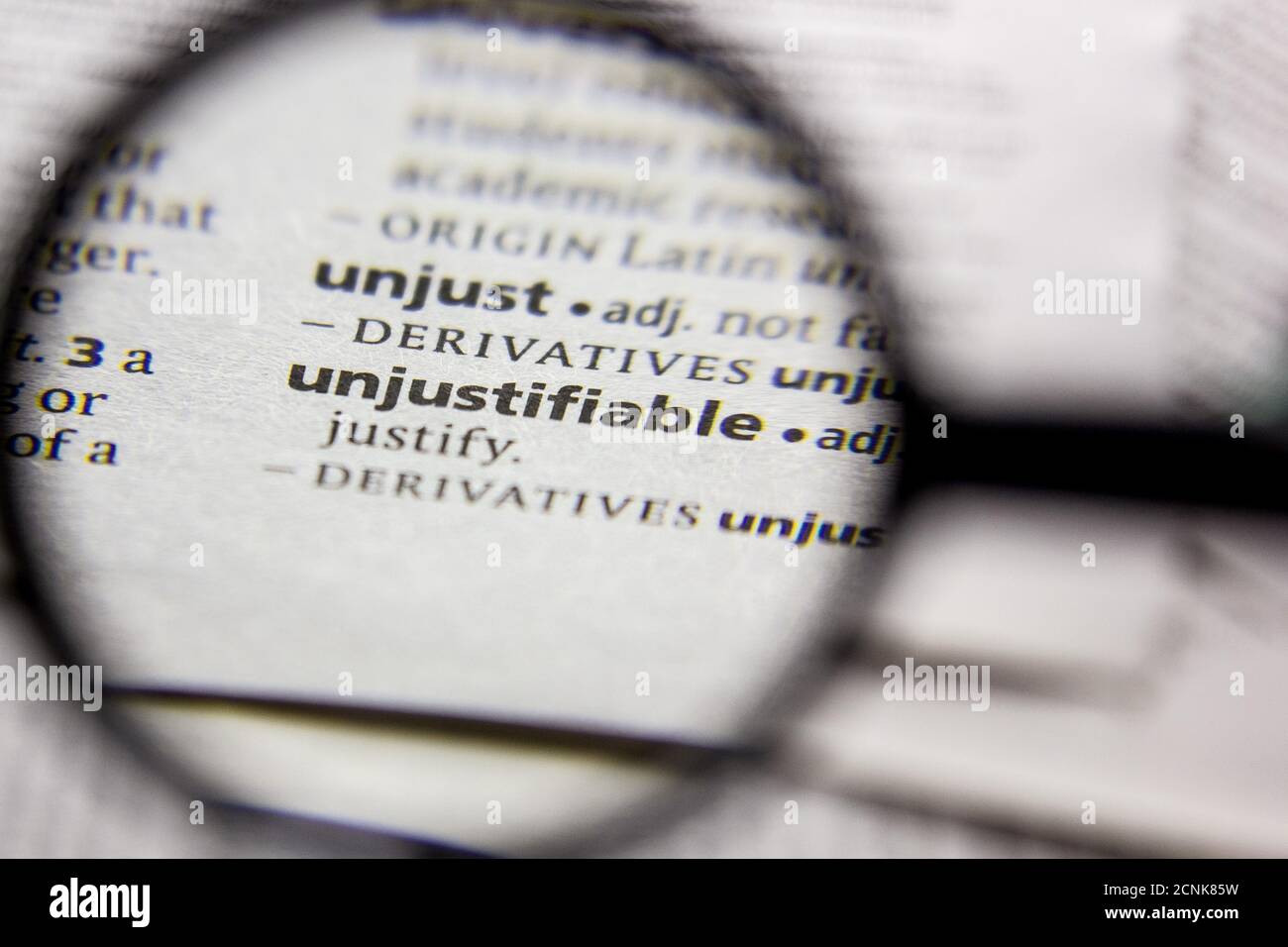 Word or phrase Unjustifiable in a dictionary Stock Photo - Alamy