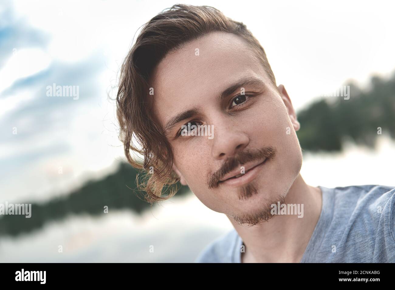 Handsome caucasian guy takes a selfie at the beach - people, lifestyle ...